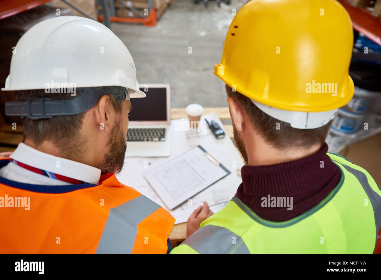 Construction Workers Discussing Plans Stock Photo - Alamy