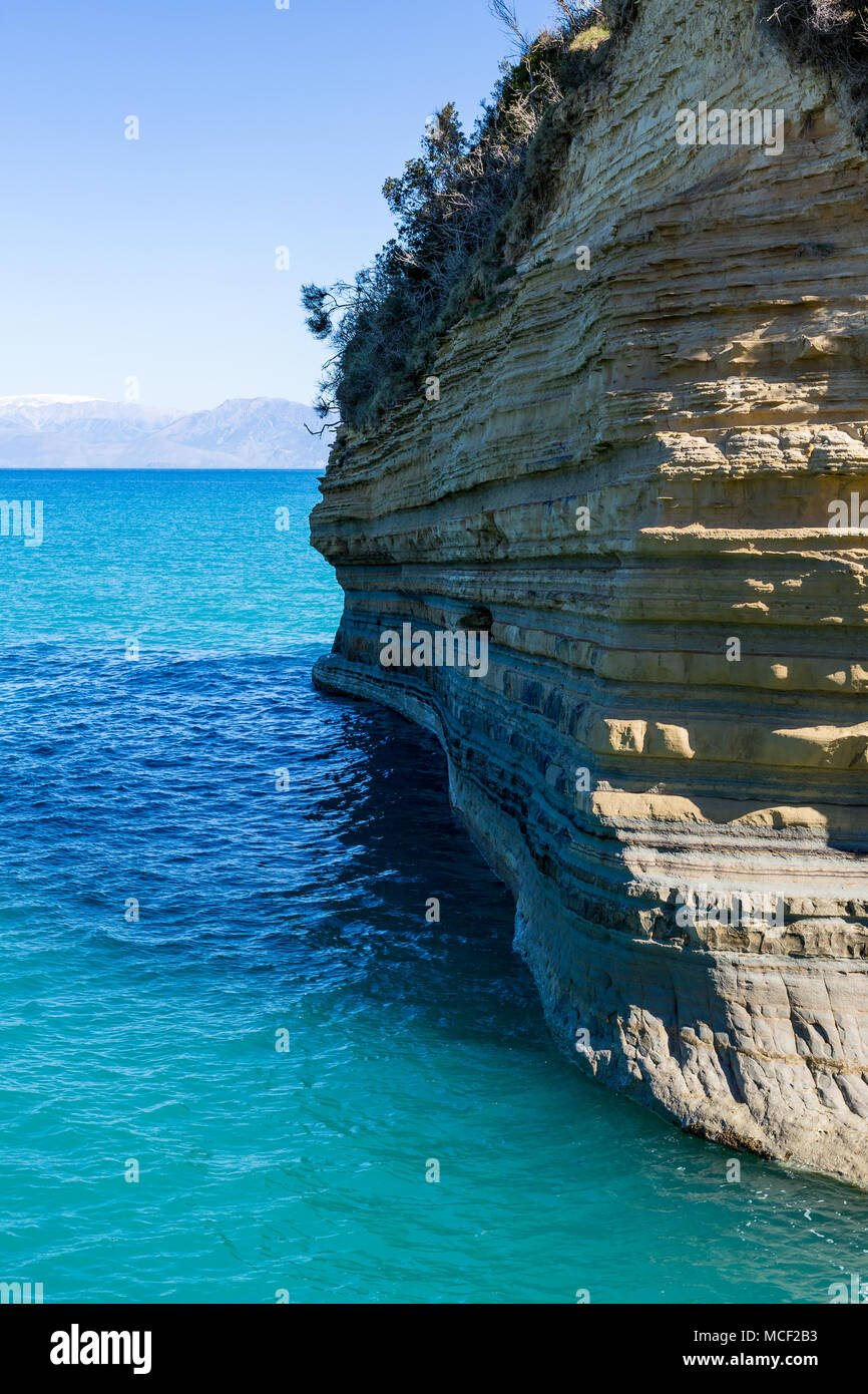 Crystal clear blue water and beautiful segmented sea rock near the ...