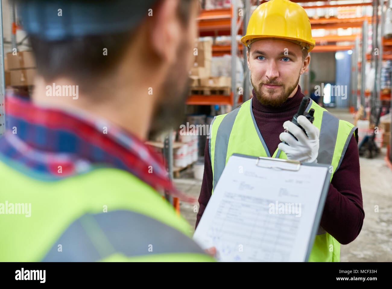 Young Worker Talking to Supervisor in Warehouse Stock Photo - Alamy