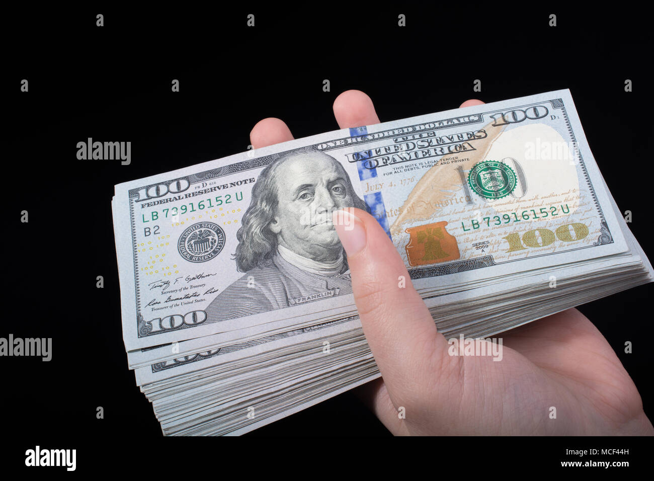 Hand holding American dollar banknotes isolated on white background ...