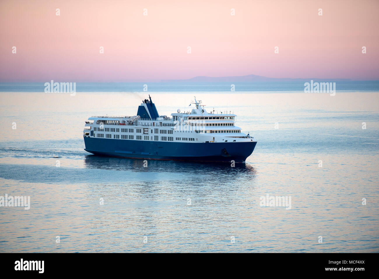 Sunset colors. A blue white ferry boat travel to igreek islands Stock ...