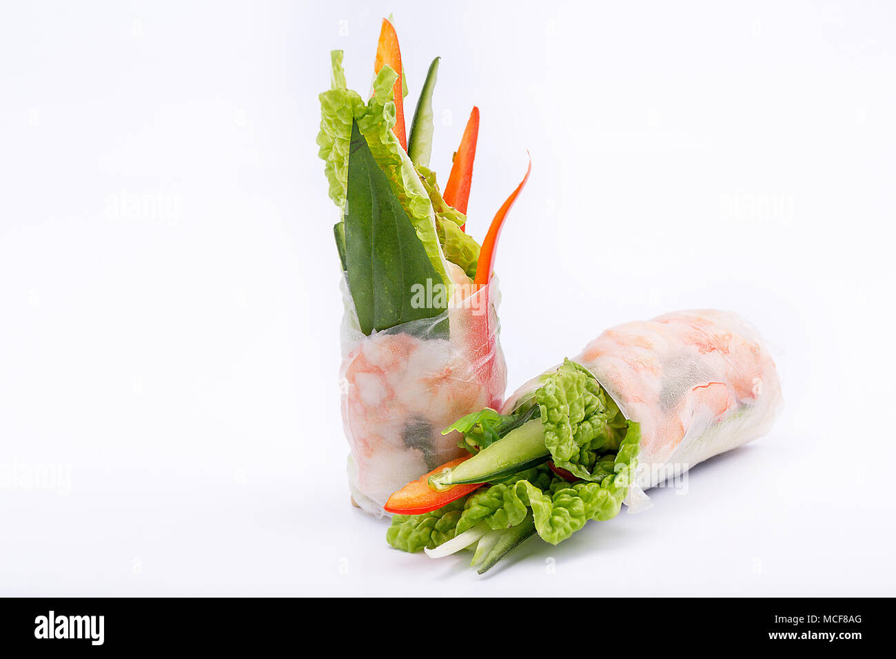 Fresh appetizing spring rolls with prawns on a white background ...