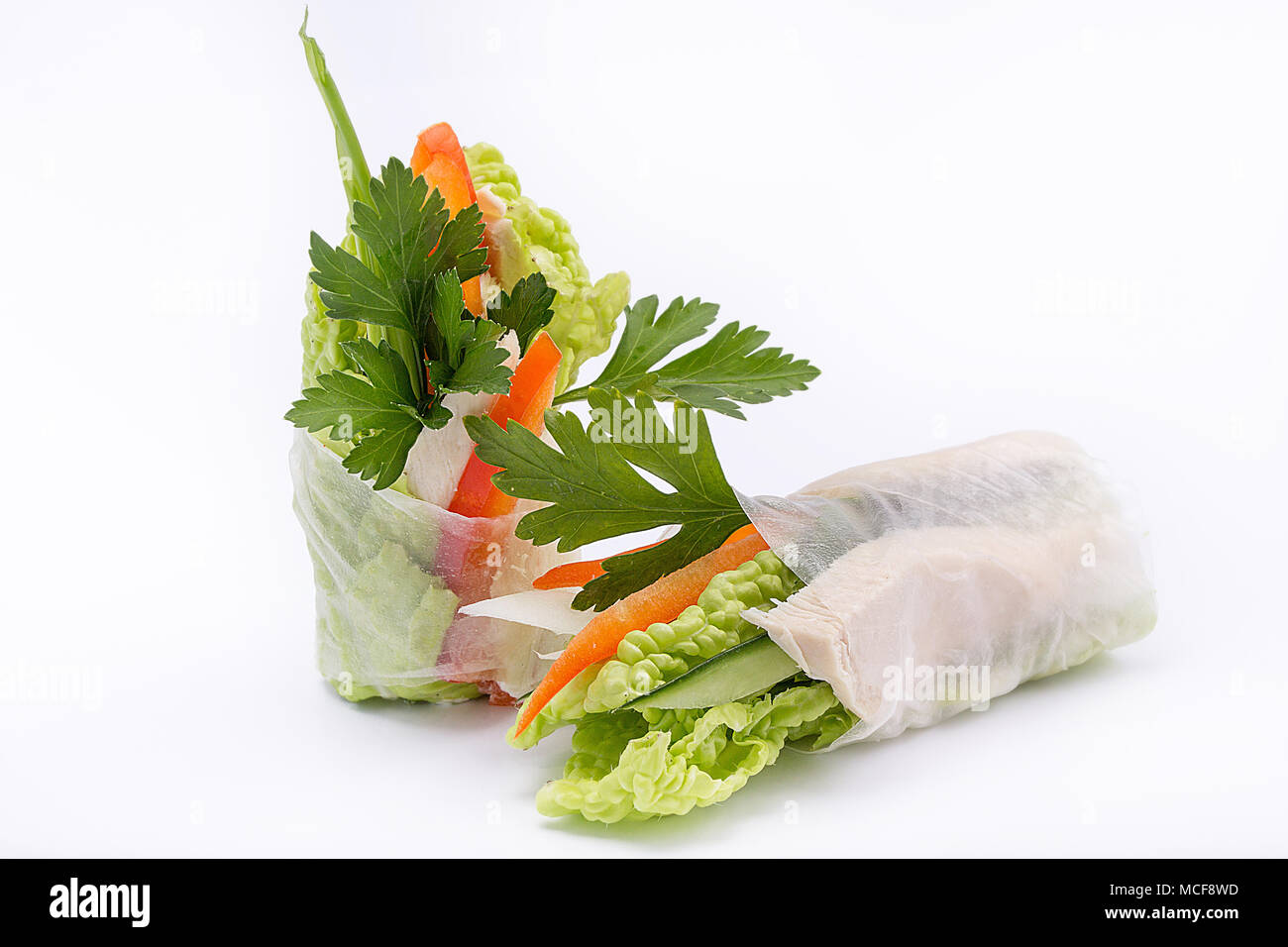 Fresh appetizing spring rolls with chicken on white background ...