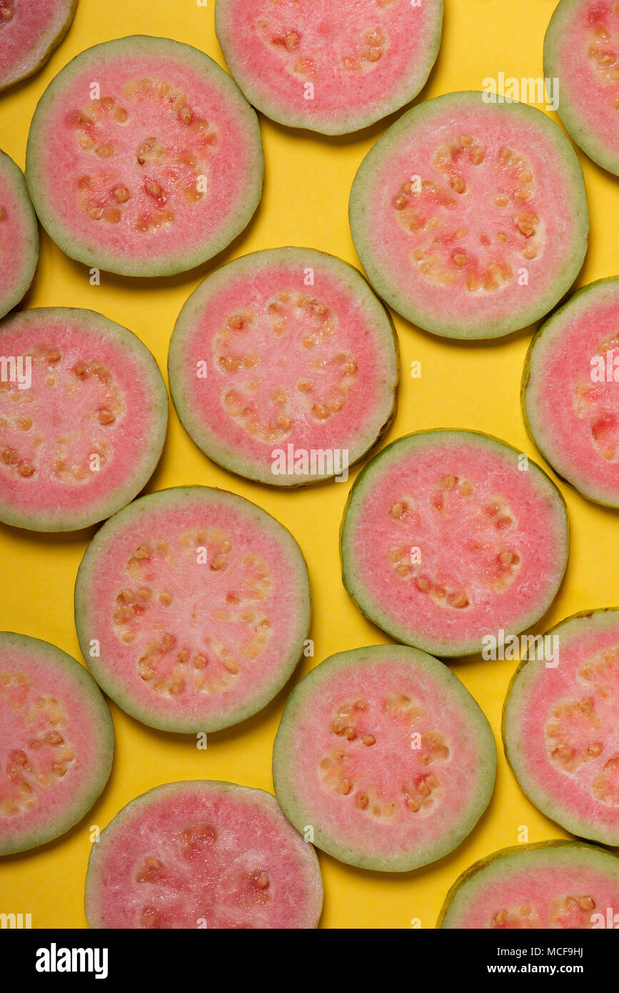 top view of slices of pink guava on yellow background Stock Photo - Alamy
