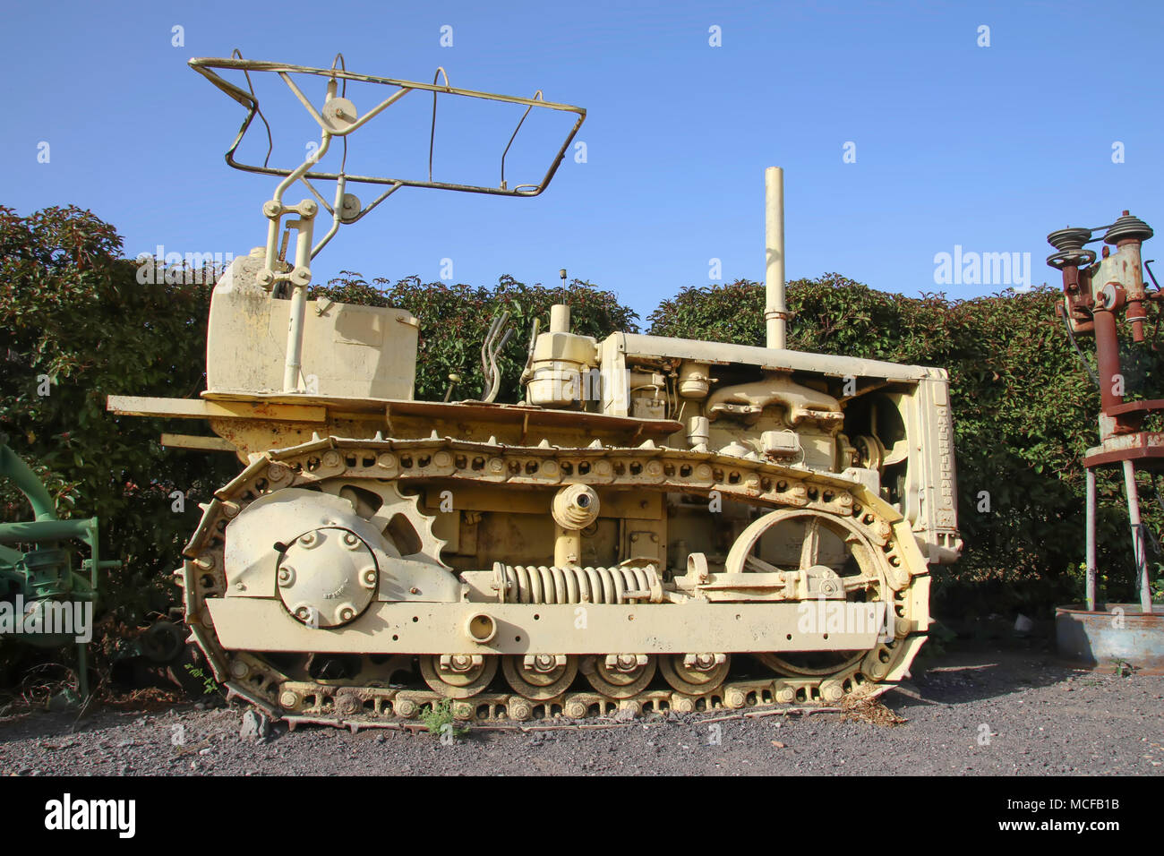 Old tractor painted in yellow color Stock Photo - Alamy
