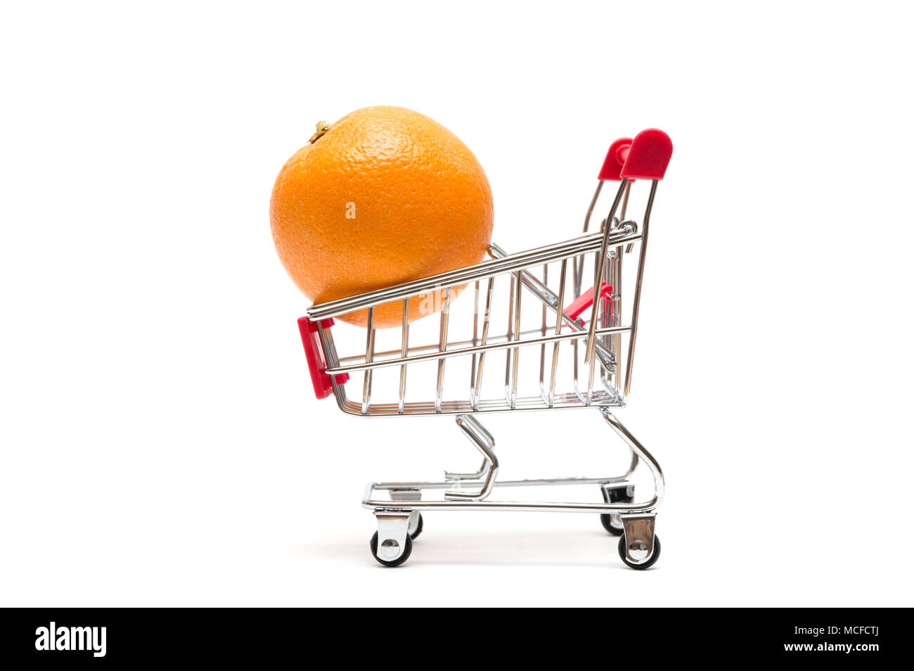 Orange and shopping cart on white background : economy concept Stock ...