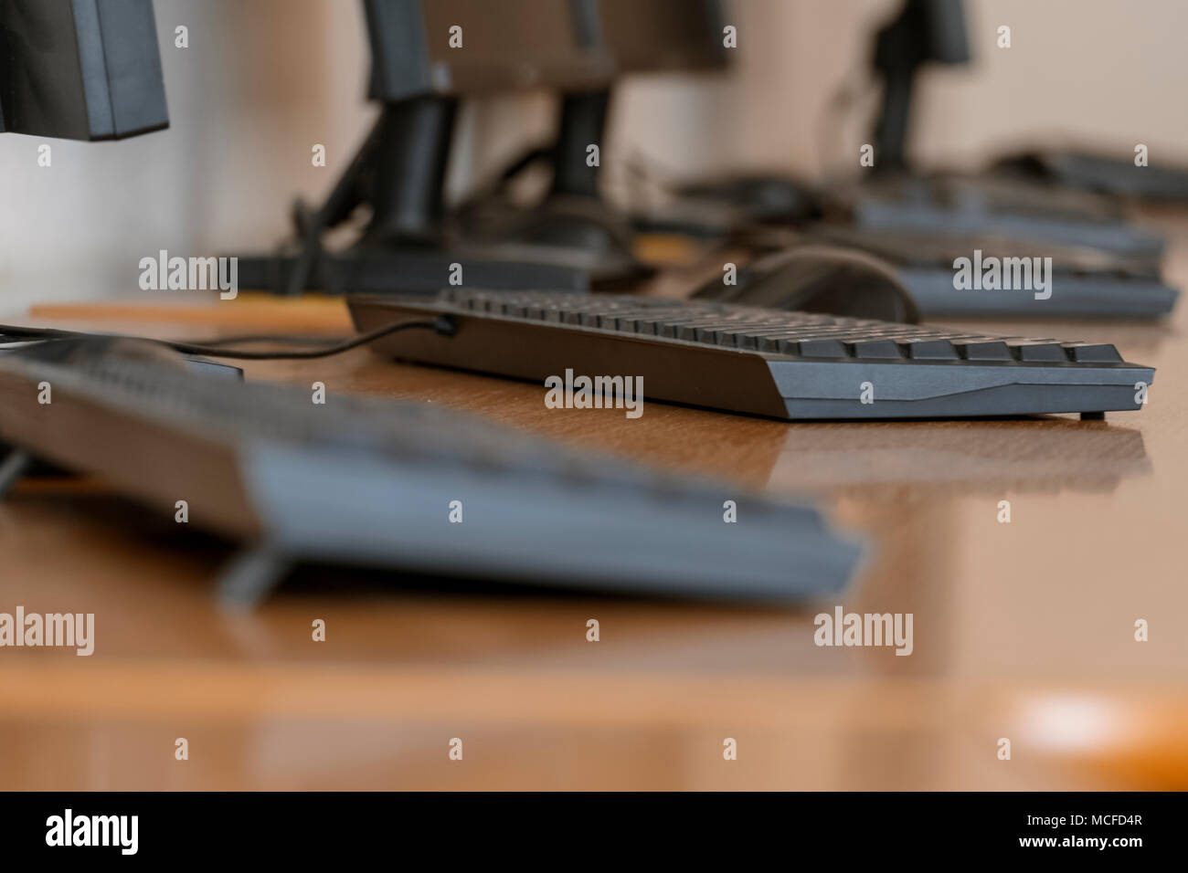 Office interior with computers on tables, shot from low angle with ...