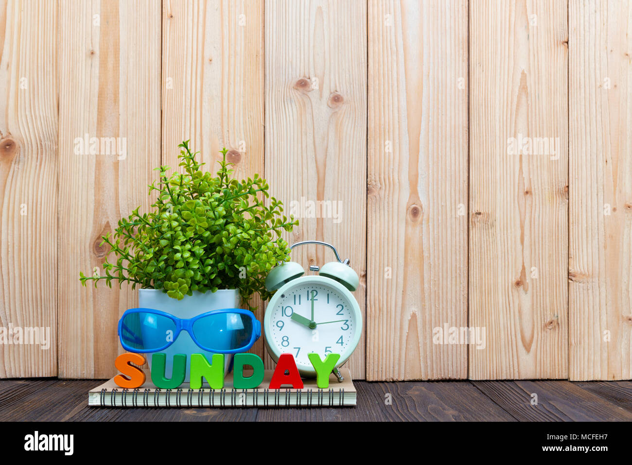 SUNDAY letters text and notebook paper, alarm clock and little ...
