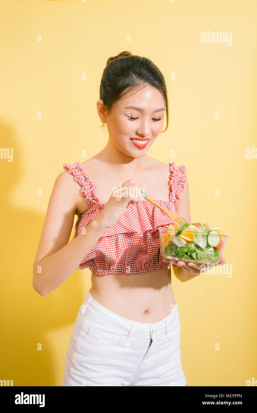 Elegant pretty slim woman eating healthy salad Stock Photo - Alamy