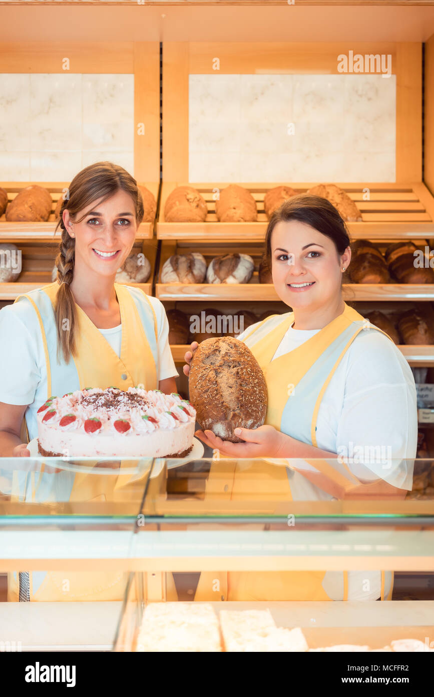 Sales women in bakery with cake and bread Stock Photo - Alamy