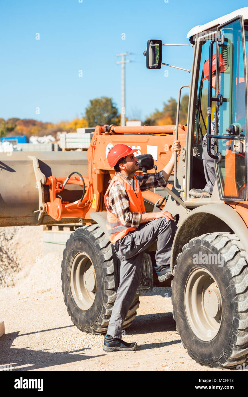 Wheel loader with tip-up bucket on construction site Stock Photo - Alamy