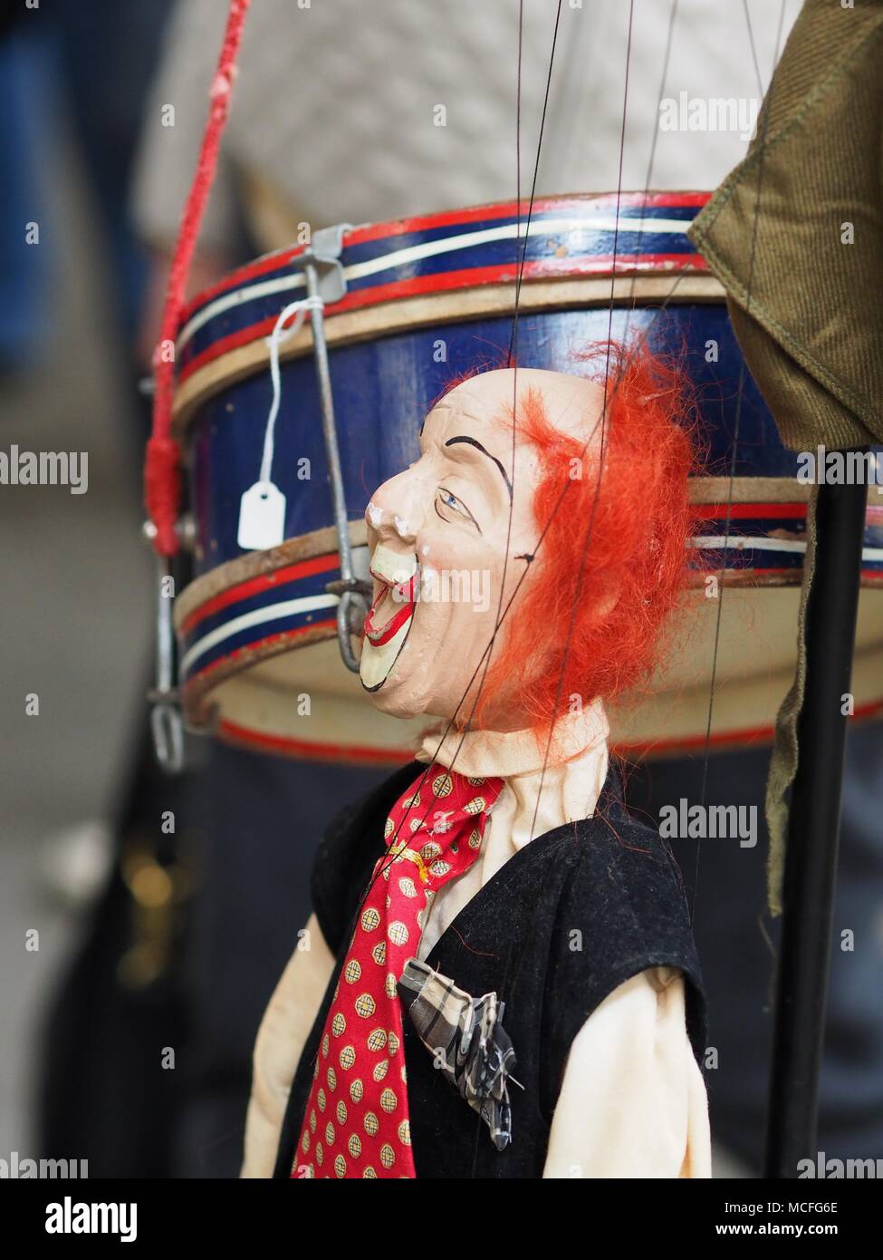 scary antique clown hanging on a stand with a drum Stock Photo - Alamy