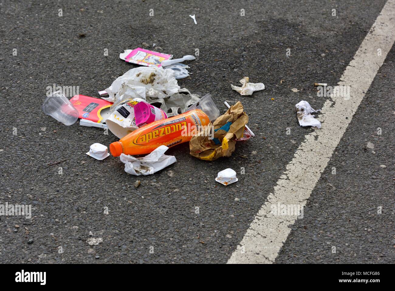 Rubbish dumped out of a car in a UK car parking space Stock Photo - Alamy