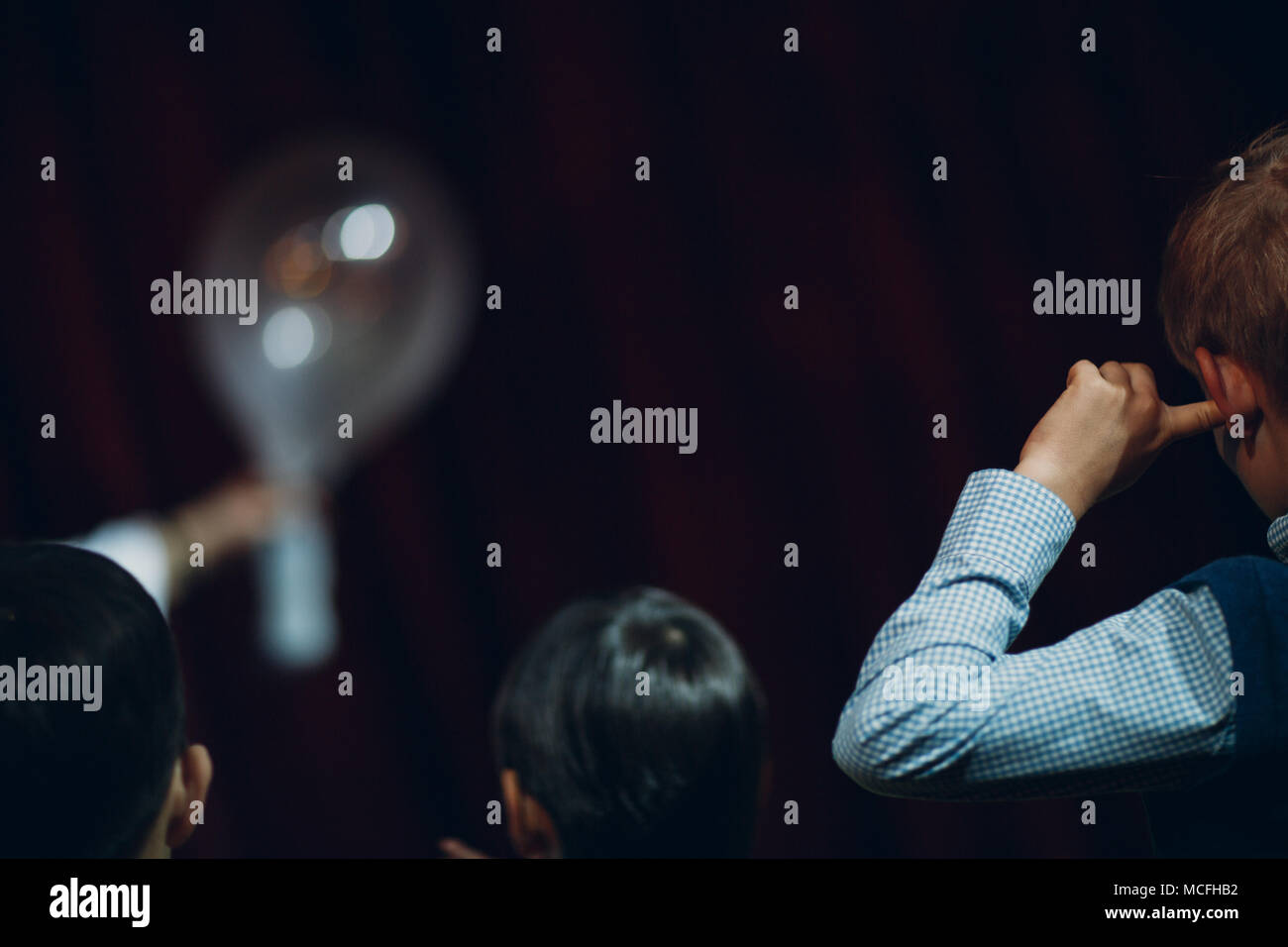 Balloon and boy stuffed ears Stock Photo - Alamy