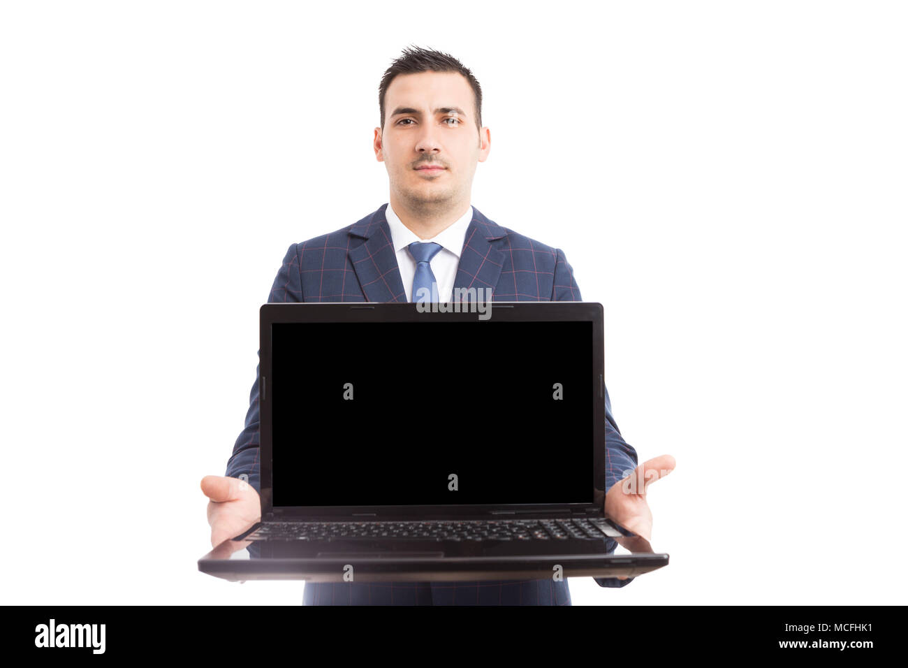 Young handsome broker or salesman holding laptop with empty black ...