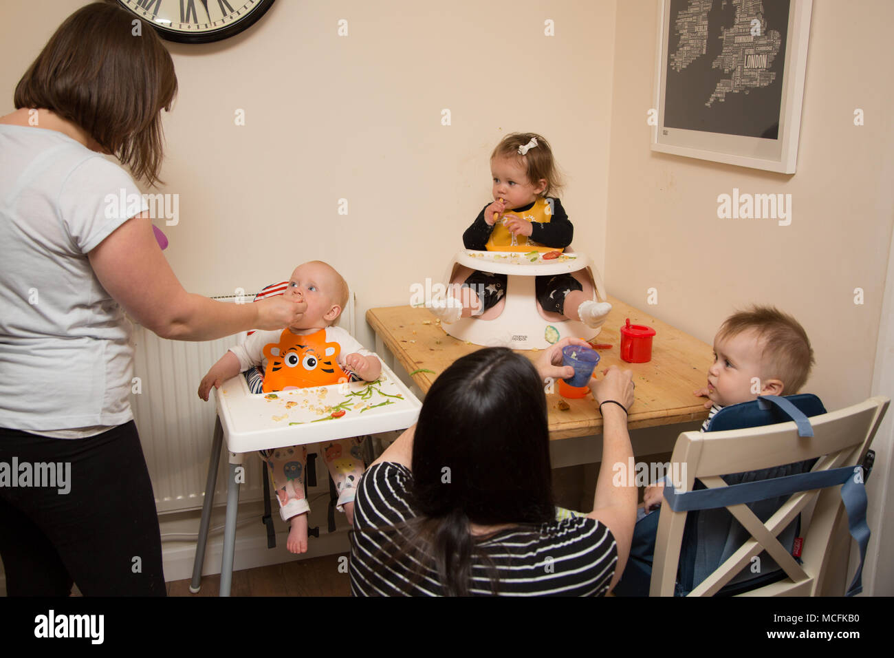 Babies and toddlers having a snack at nursery, UK Stock Photo - Alamy