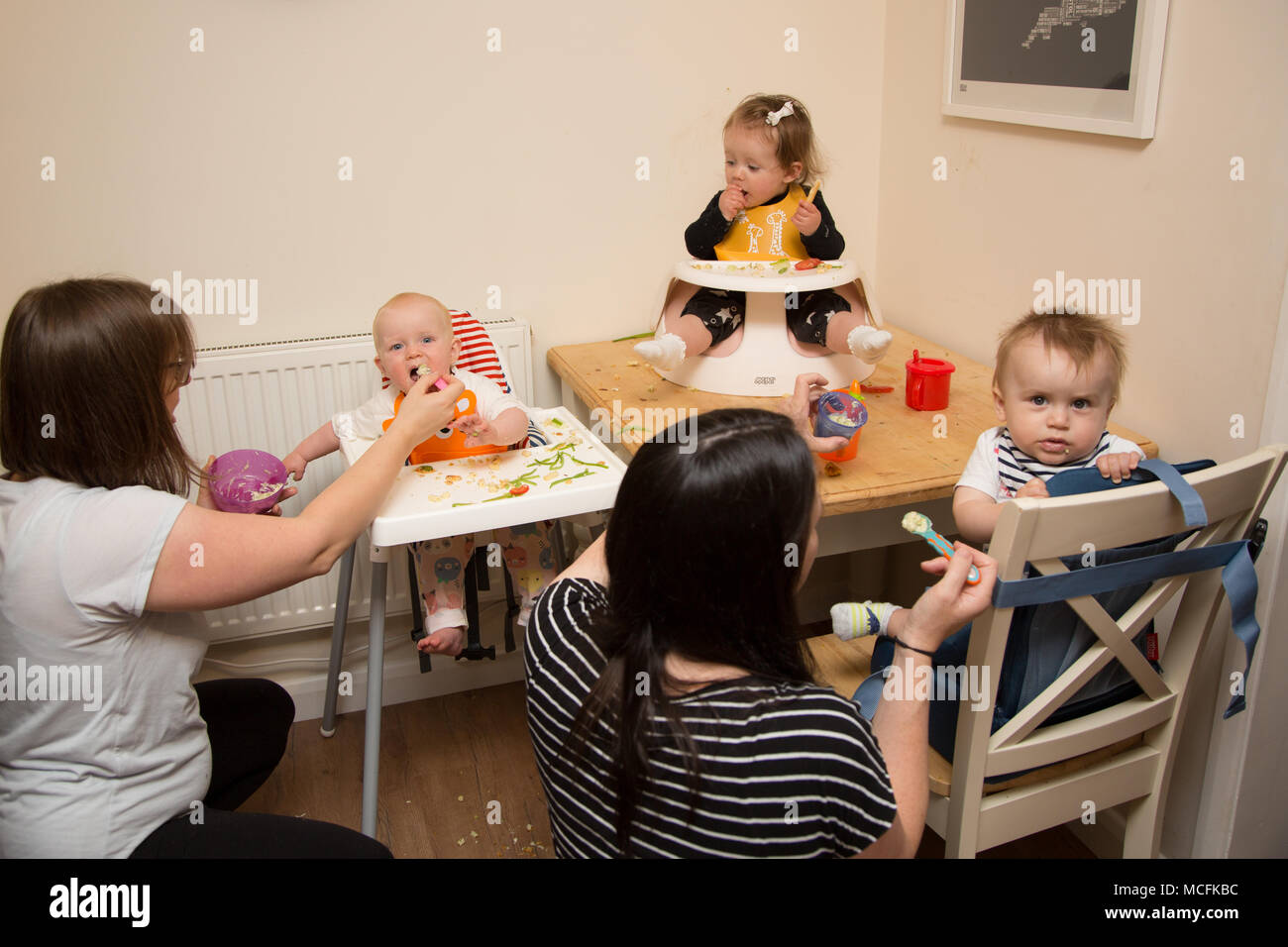 Babies and toddlers having a snack at nursery, UK Stock Photo - Alamy