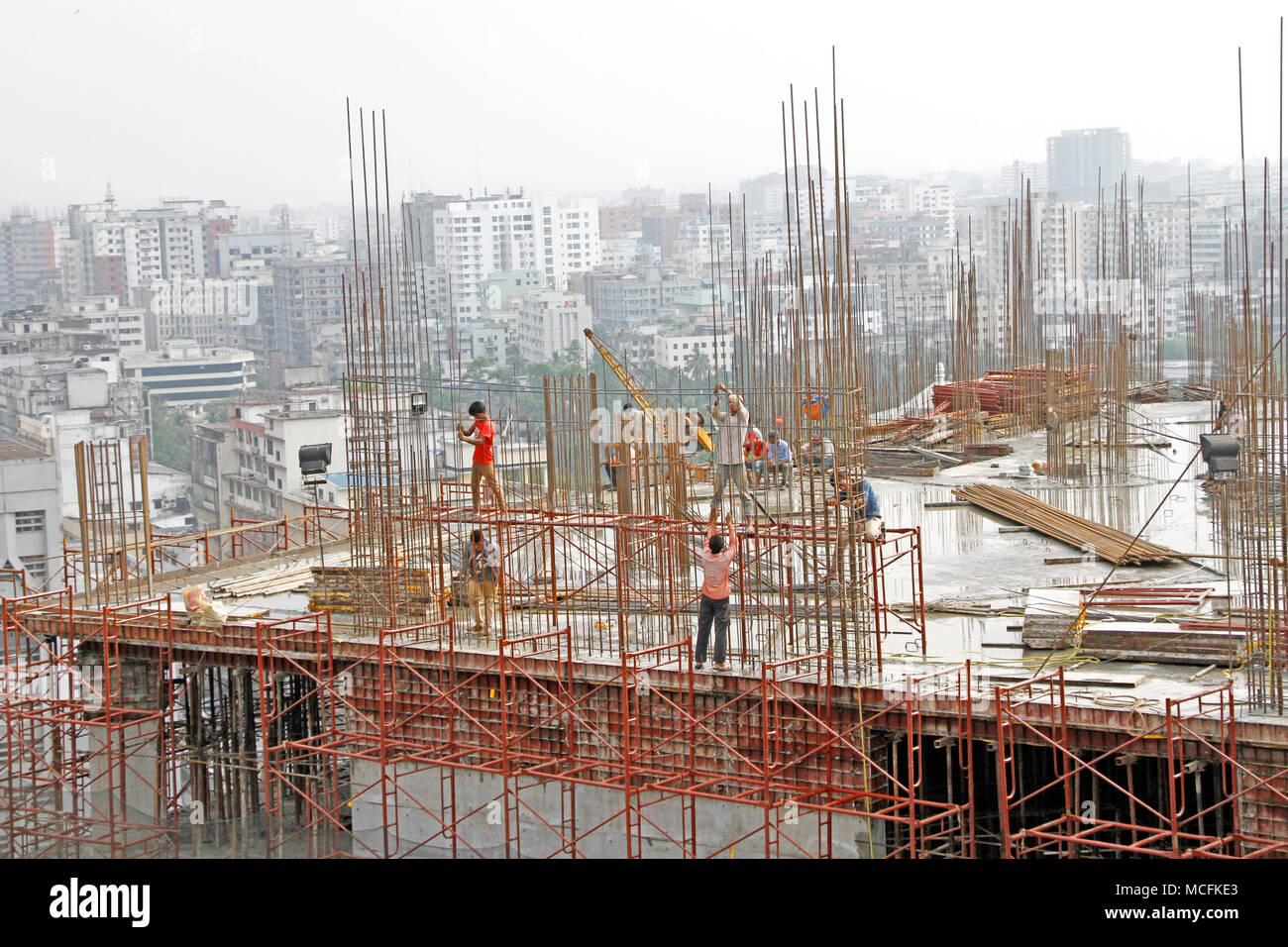 Dhaka, Bangladesh. Bangladeshi construction labors work on a new high-rise building in Dhaka ...