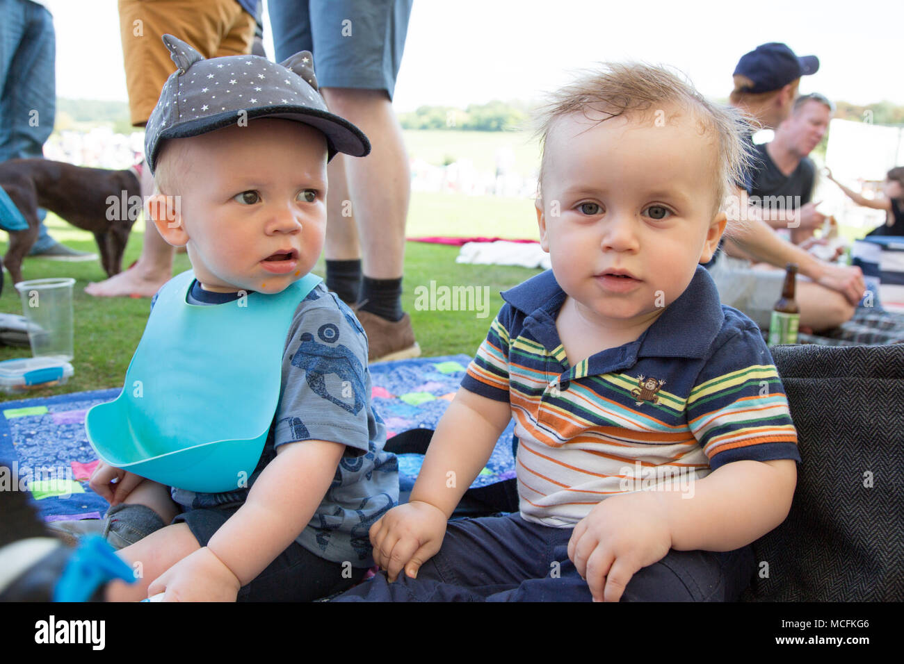 Babies playing outside Stock Photo - Alamy
