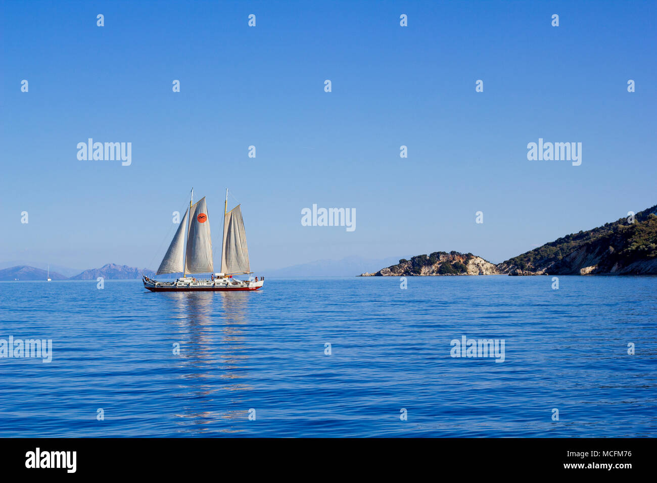 Long Sail Boat with sails up Stock Photo - Alamy
