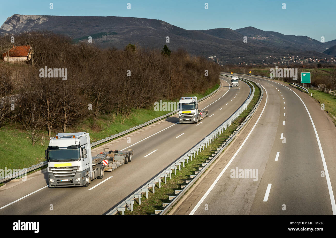 Convoy of Semi Trucks without trailers in country highway Traffic Stock ...