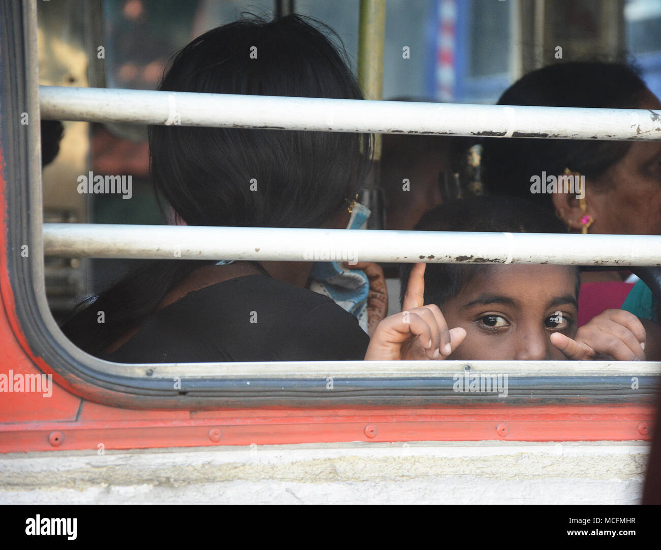 Child peering out bus window hi-res stock photography and images - Alamy