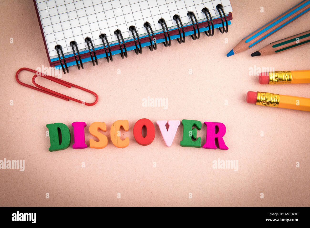 Discover. Wooden letters on the office desk Stock Photo - Alamy