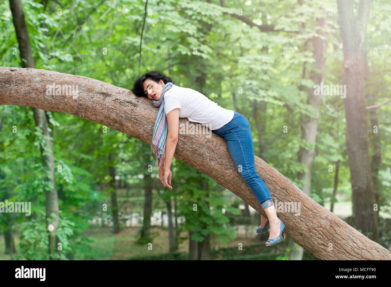 pretty woman sleeping in a tree after being over worked and having ...