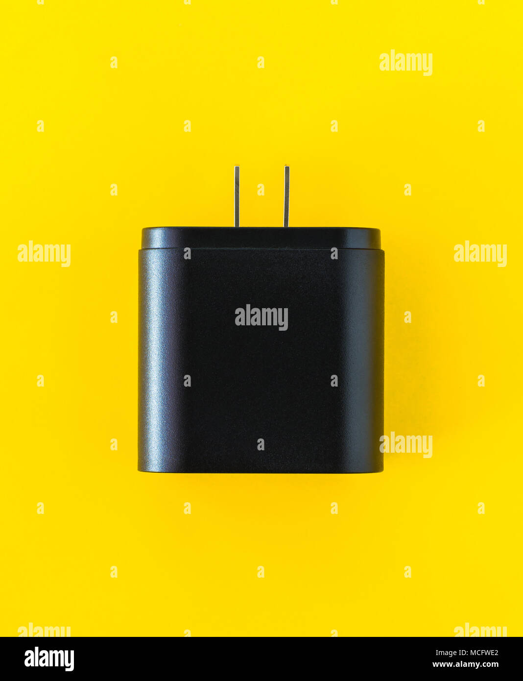 Black Charger Power Adapter on Yellow Background Stock Photo - Alamy