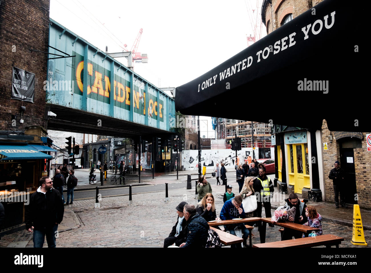 The iconic London landmark of the Camden Lock bridge above a cafe ...