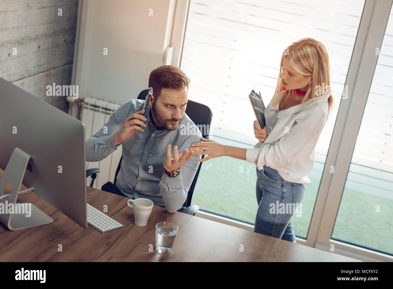 Young business colleagues arguing at the office Stock Photo - Alamy