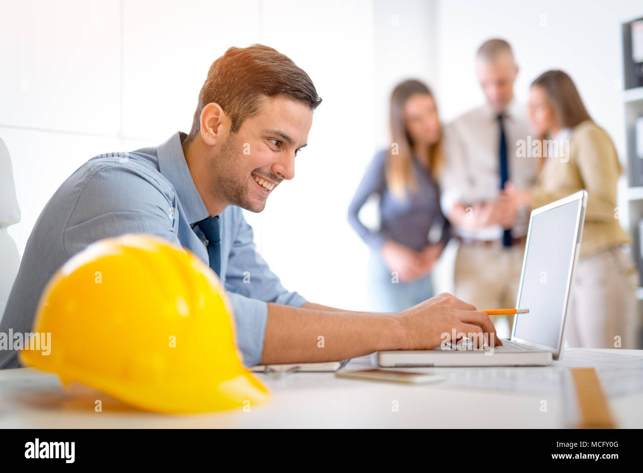 Young arabian male constructor working at laptop in the office ...