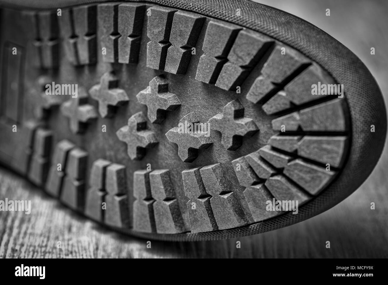 close up of the bottom of a pair of shoes showing the tread pattern ...