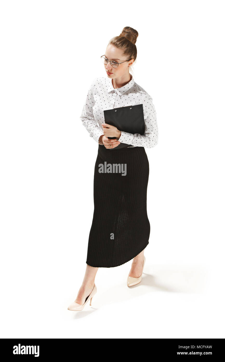 Full length portrait of a smiling female teacher holding a folder ...