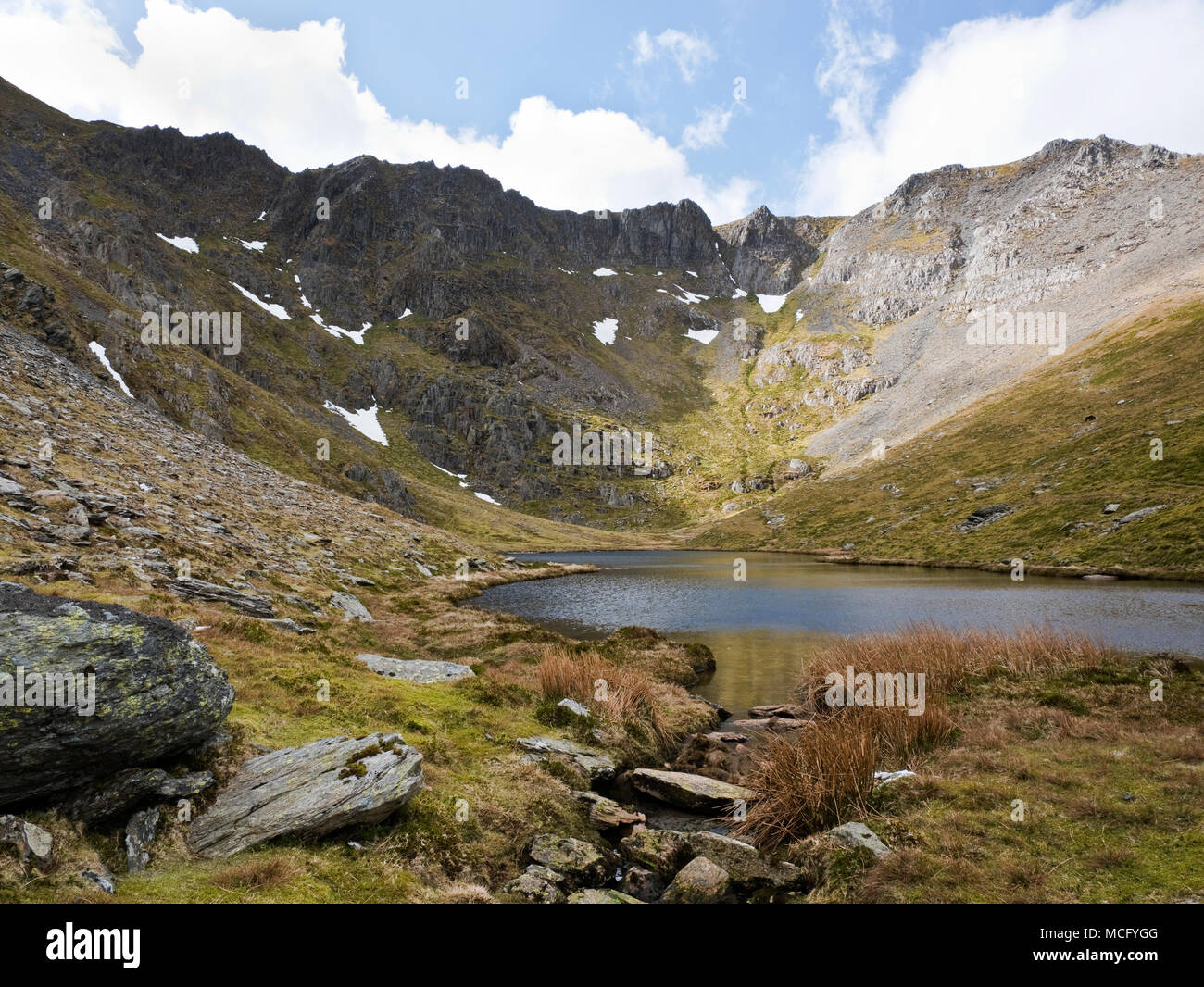 The mountain lake of Ffynnon Caseg, nestled beneath the crags of Yr ...