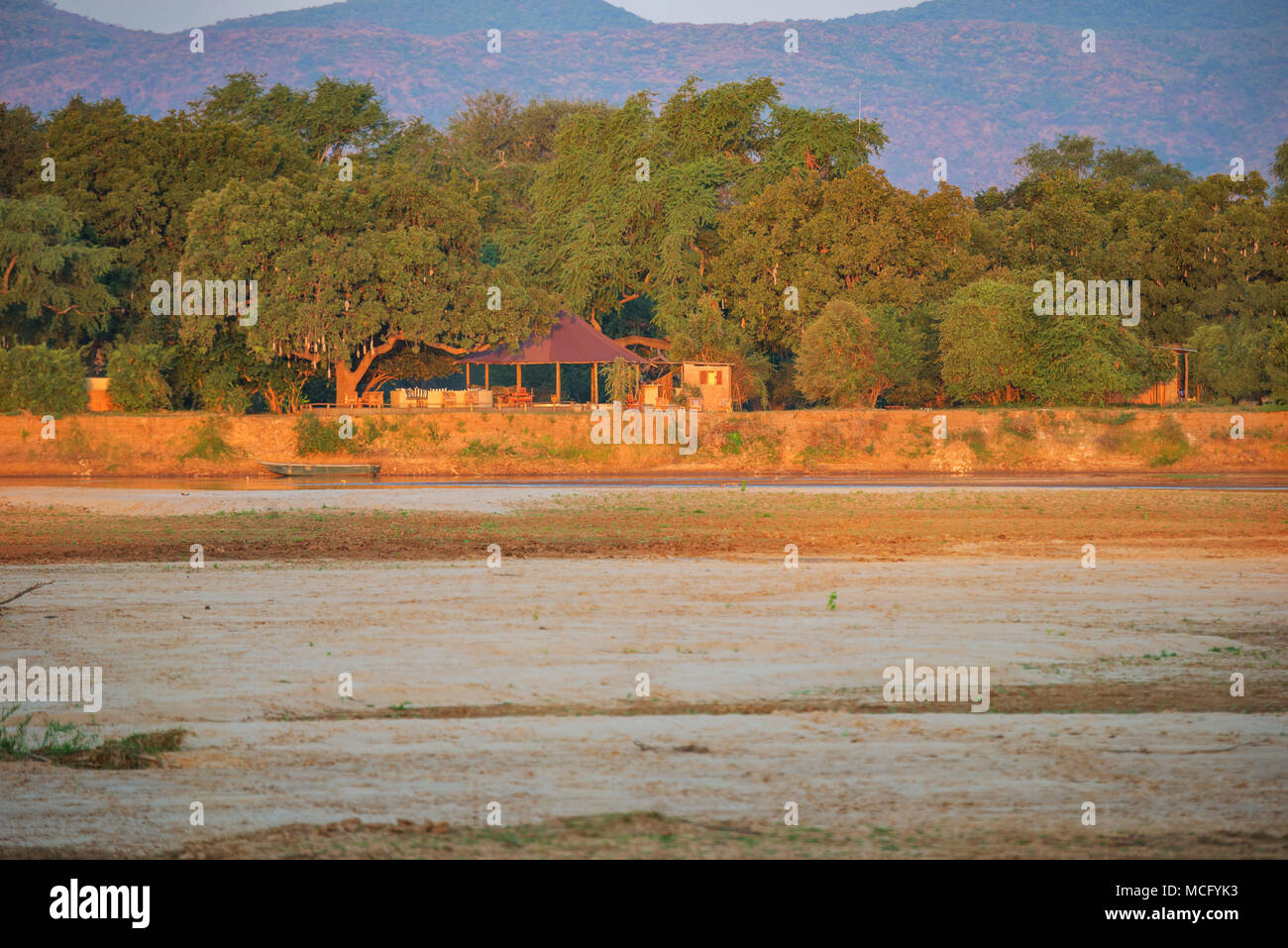 BEAUTIFUL GOLDEN LIGHT SHINING ON KAPAMBA BUSH CAMP, ZAMBIA Stock Photo ...