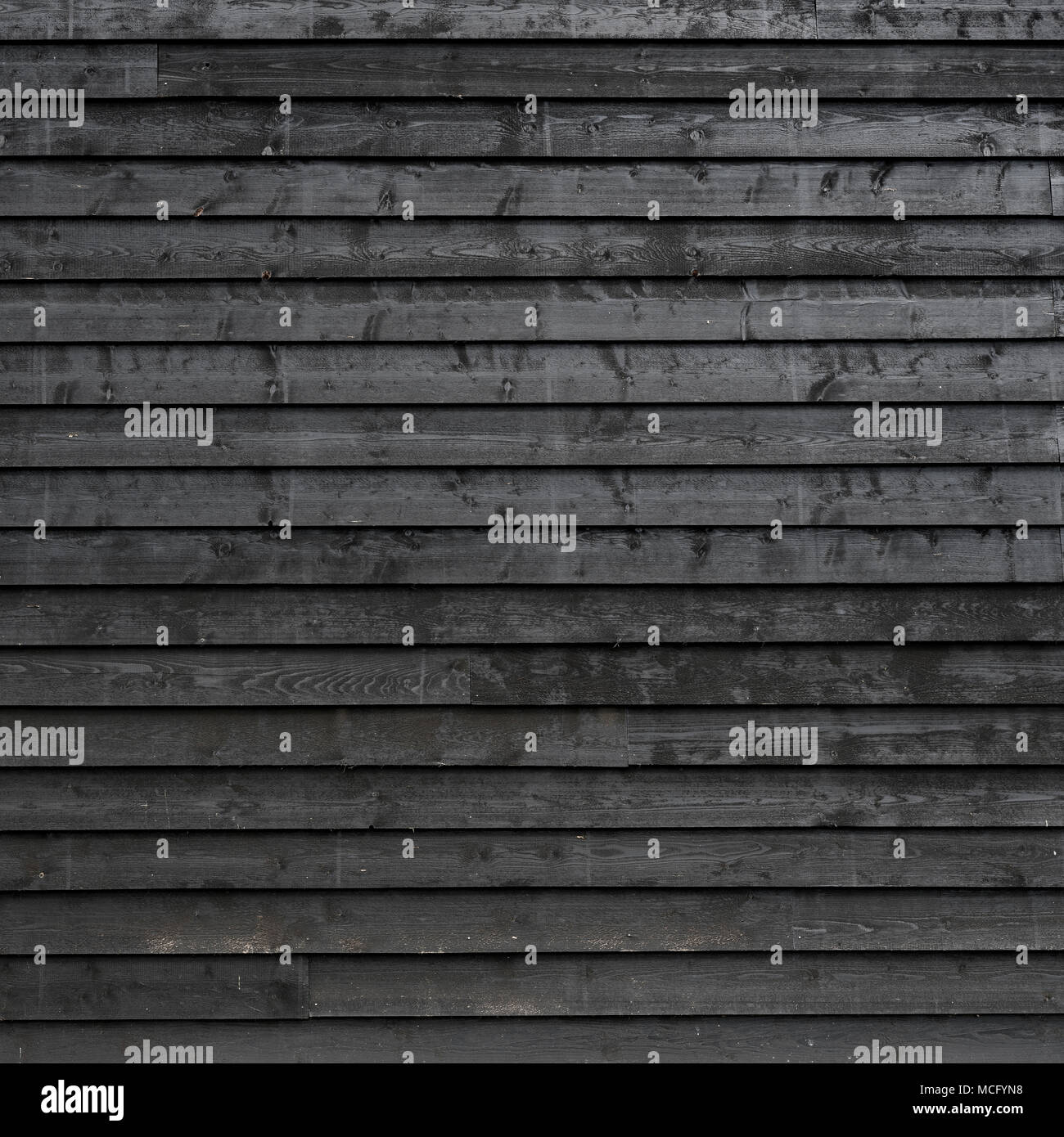 square part of black painted wooden planks of barn wall or shed Stock ...