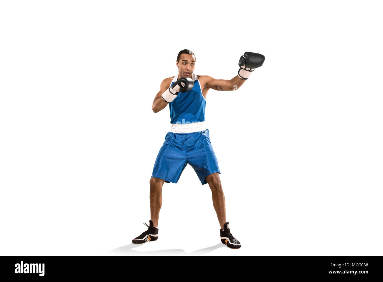 Sporty man during boxing exercise. Photo of boxer on white background ...