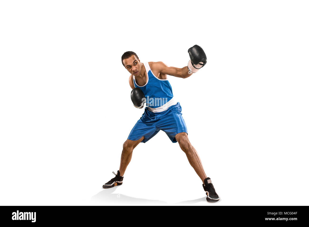 Sporty man during boxing exercise. Photo of boxer on white background ...
