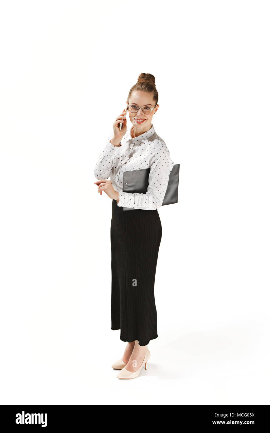 Full length portrait of a smiling female teacher holding a folder ...