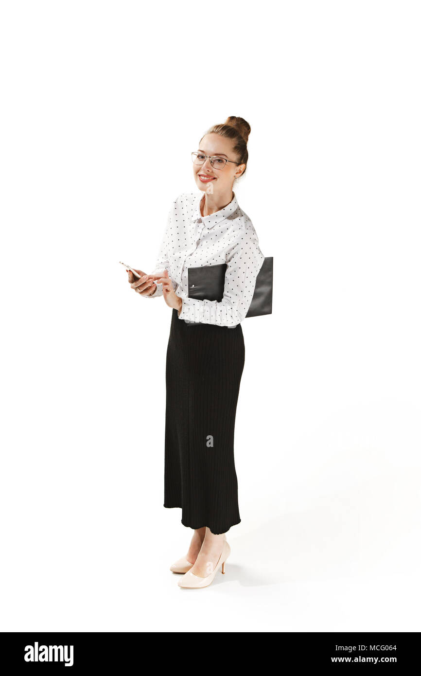 Full length portrait of a smiling female teacher holding a folder ...