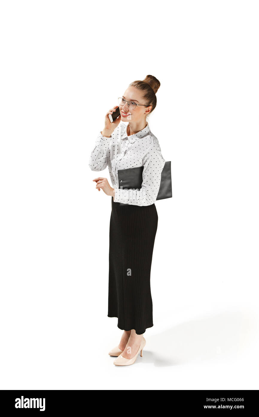 Full length portrait of a smiling female teacher holding a folder ...