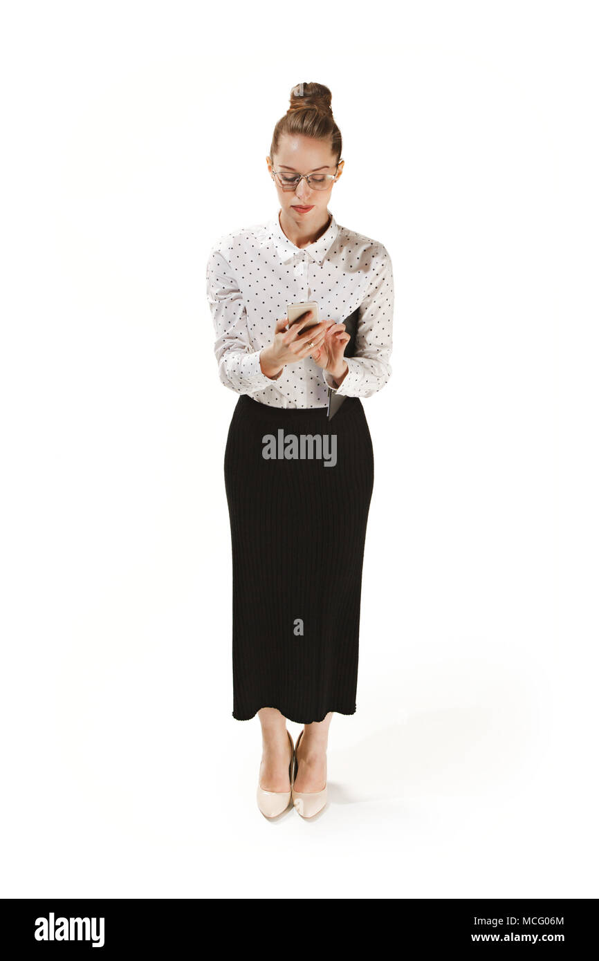 Full length portrait of a smiling female teacher holding a folder ...