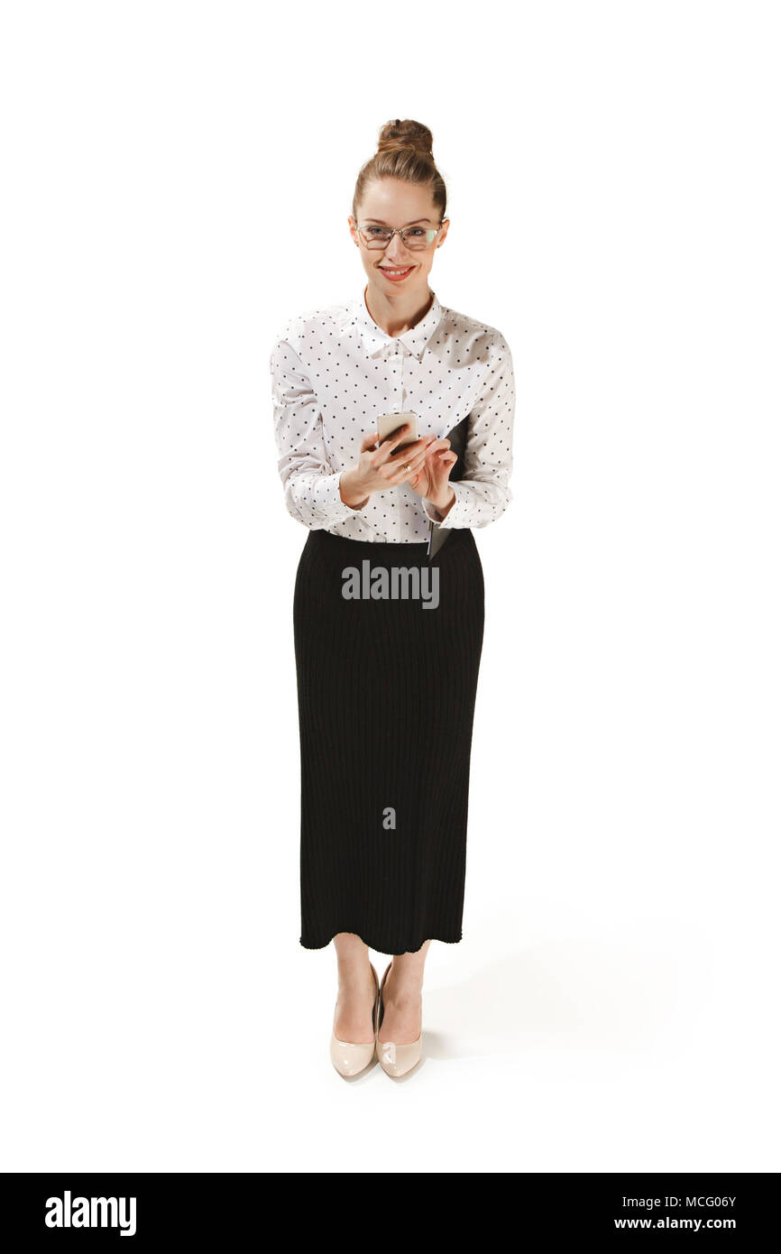 Full length portrait of a smiling female teacher holding a folder ...