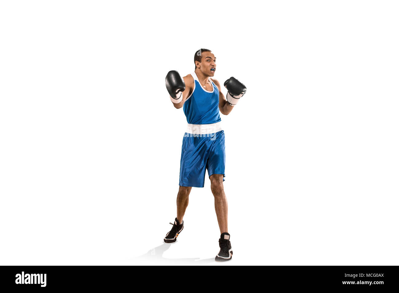 Sporty man during boxing exercise. Photo of boxer on white background ...