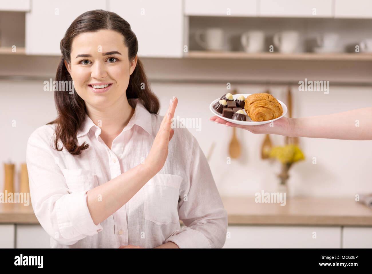 Woman refusing chocolate hi-res stock photography and images - Alamy