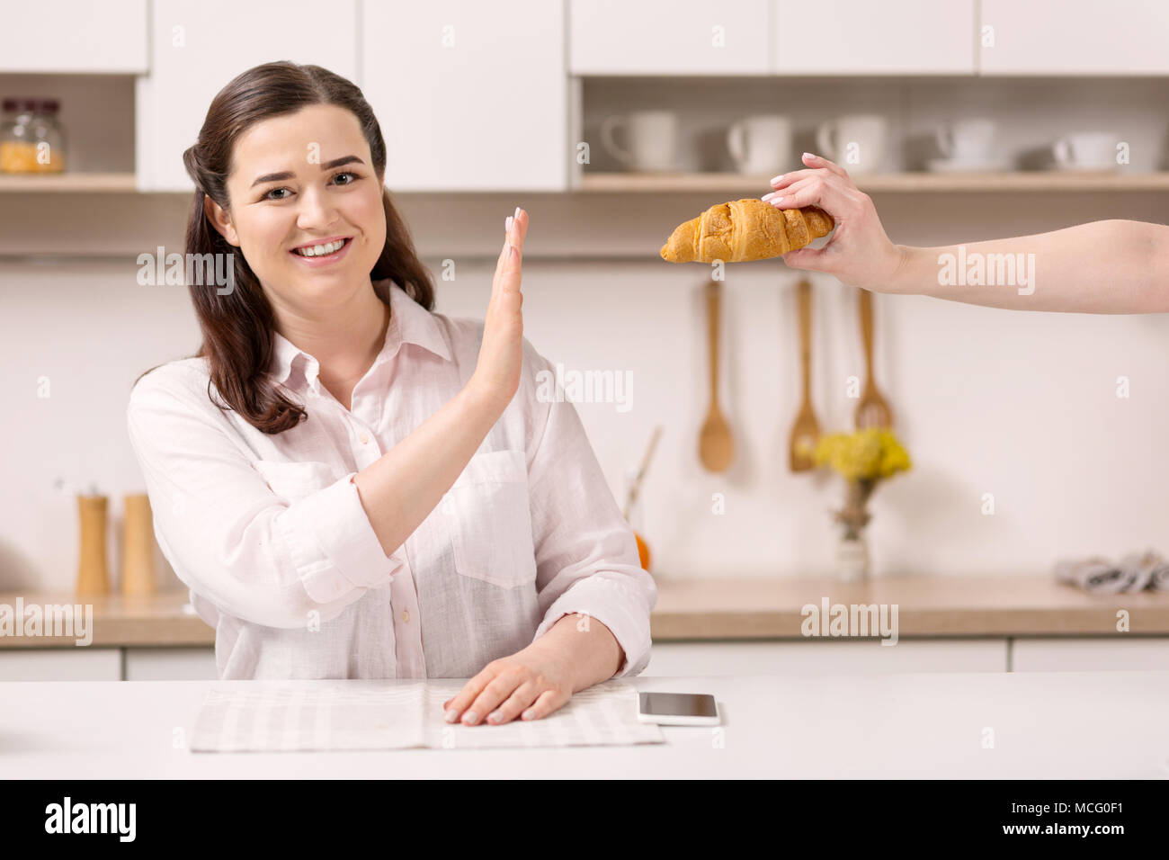 Happy joyful woman denying from croissant Stock Photo - Alamy