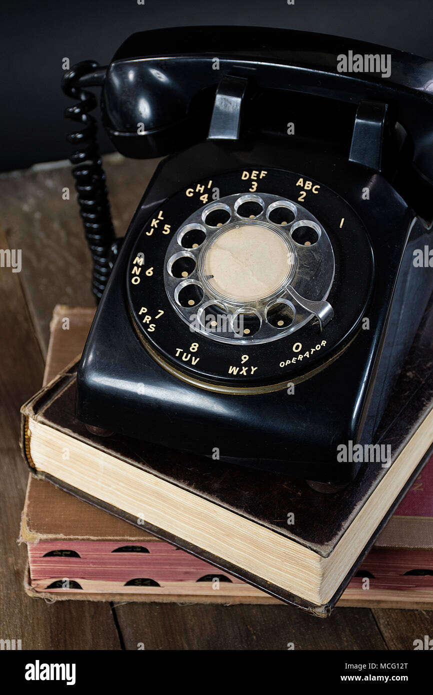 retro black telephone and books on rustic wood Stock Photo - Alamy