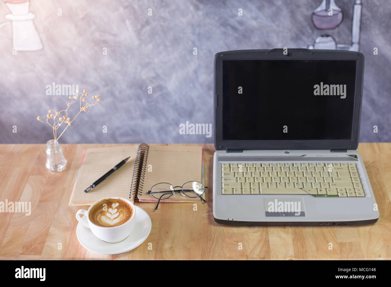 Top view of working table bar with coffee , notebook , pen , glasses ...