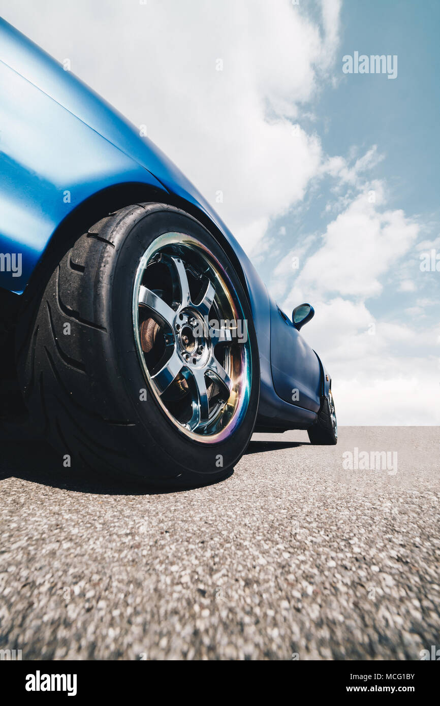 wide angle view of a modern custom fast car with decorated wheel ...